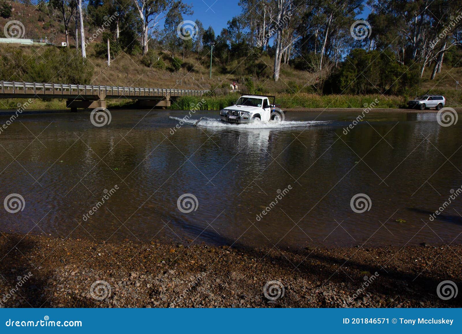 Ute Crossing a Flowing River Stock Image - Image of people, structure ...