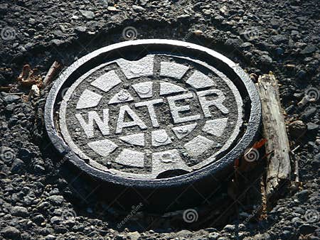 Utilities: Water Main Cover Stock Photo - Image of manhole, street ...