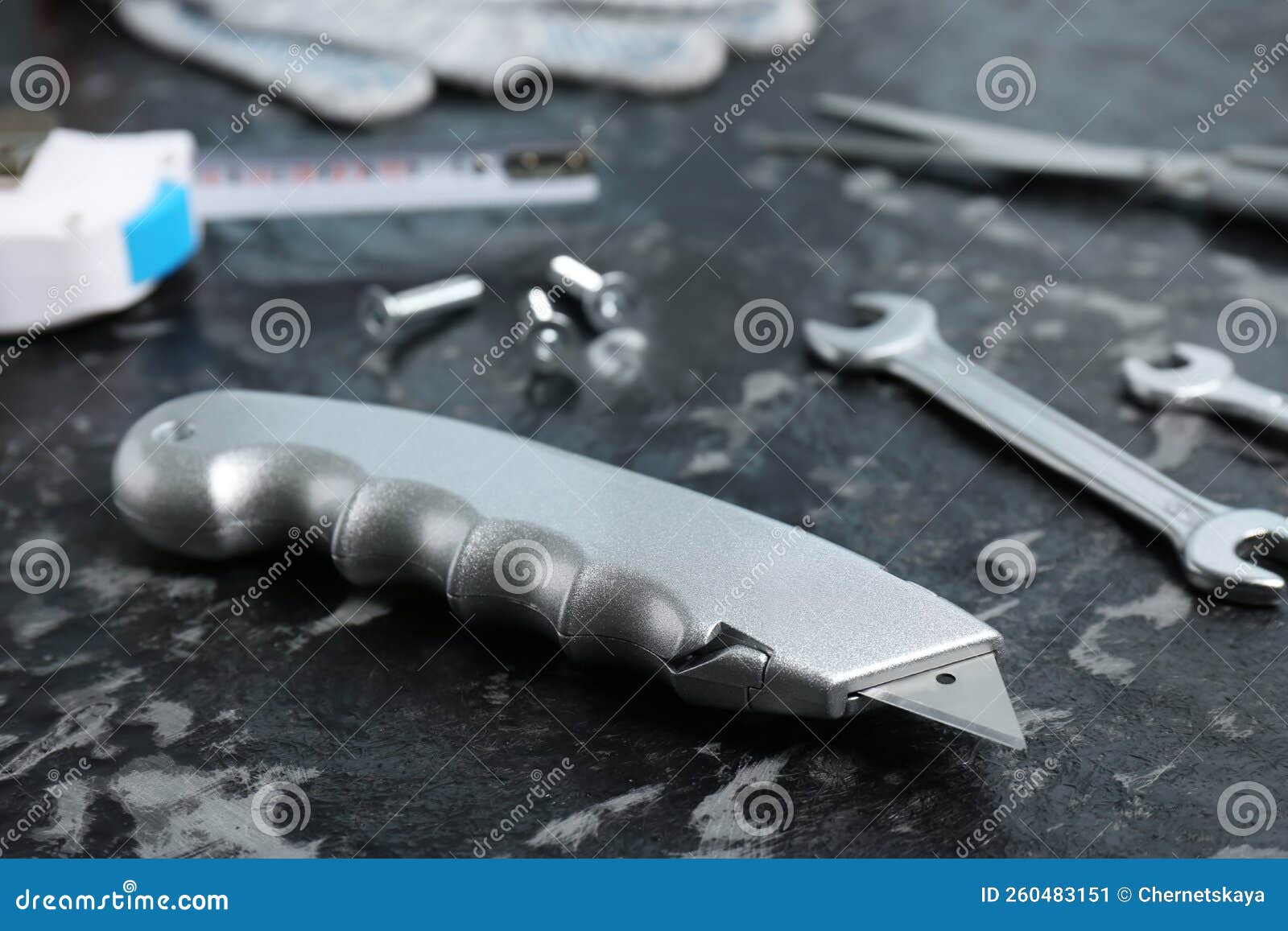 Utility Knife and Different Tools on Black Textured Table, Closeup ...