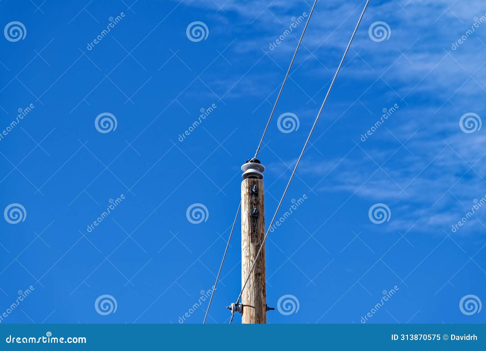 A Utility Pole Supports Two Cables with a Clear Blue Sky Stock Image ...