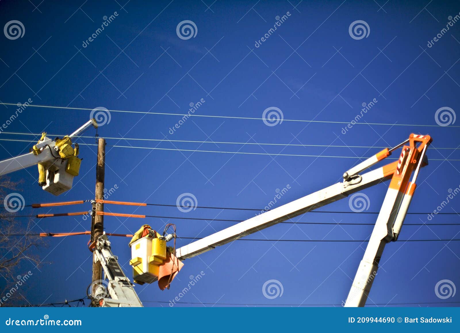 Electric Company Performing Utility Work Up on Power Lines Stock Photo ...