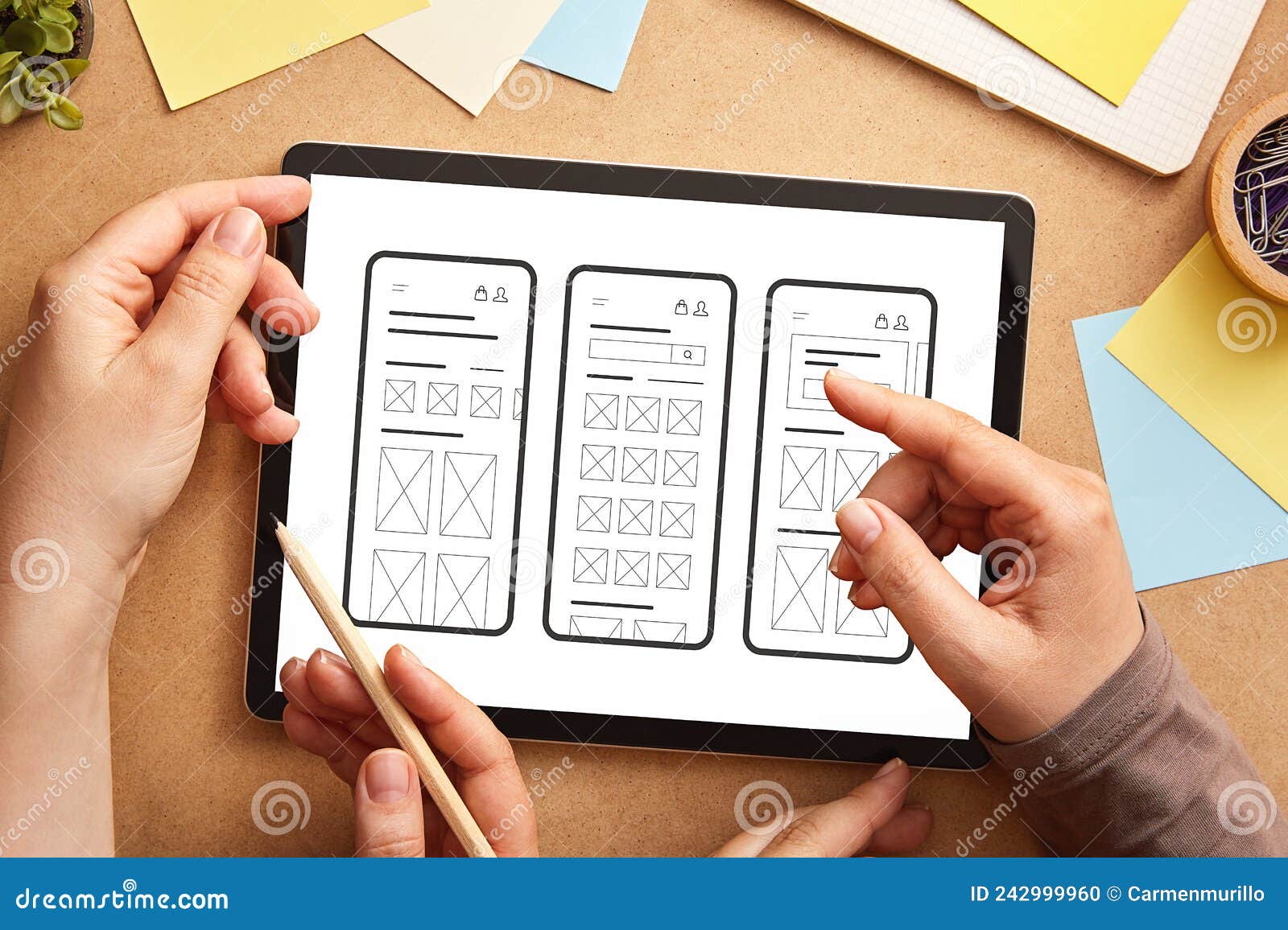 UX Designers Working on Mobile App Wireframes with a Tablet Stock Photo ...