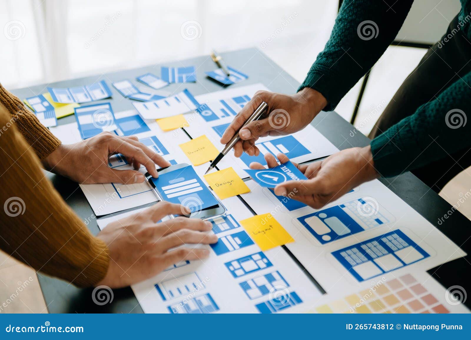 Ux Developer And Ui Designer Brainstorming About Mobile App Interface Wireframe Design With