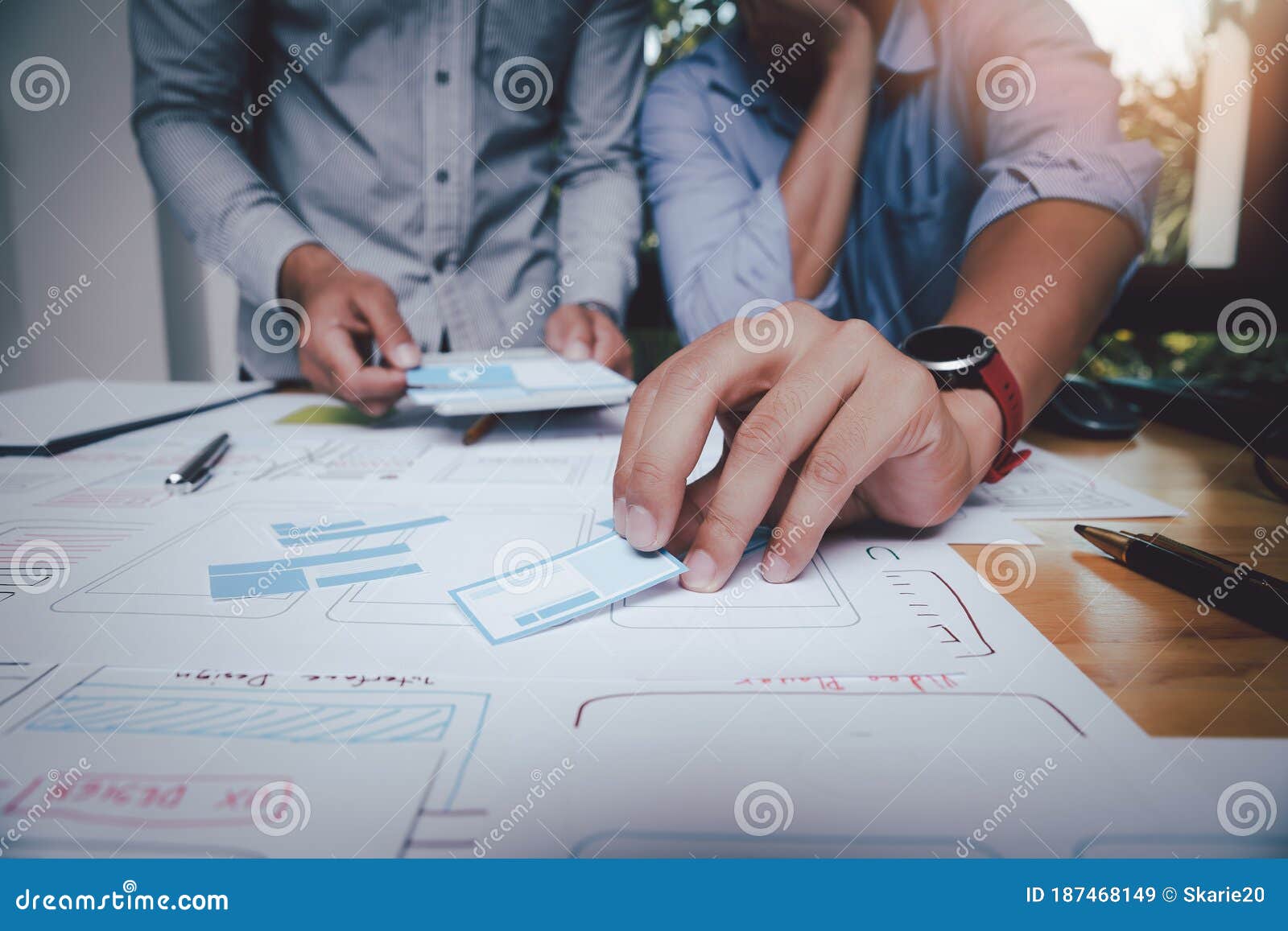 UX or UI Designers Designing on Their Smartphone Application Layout ...