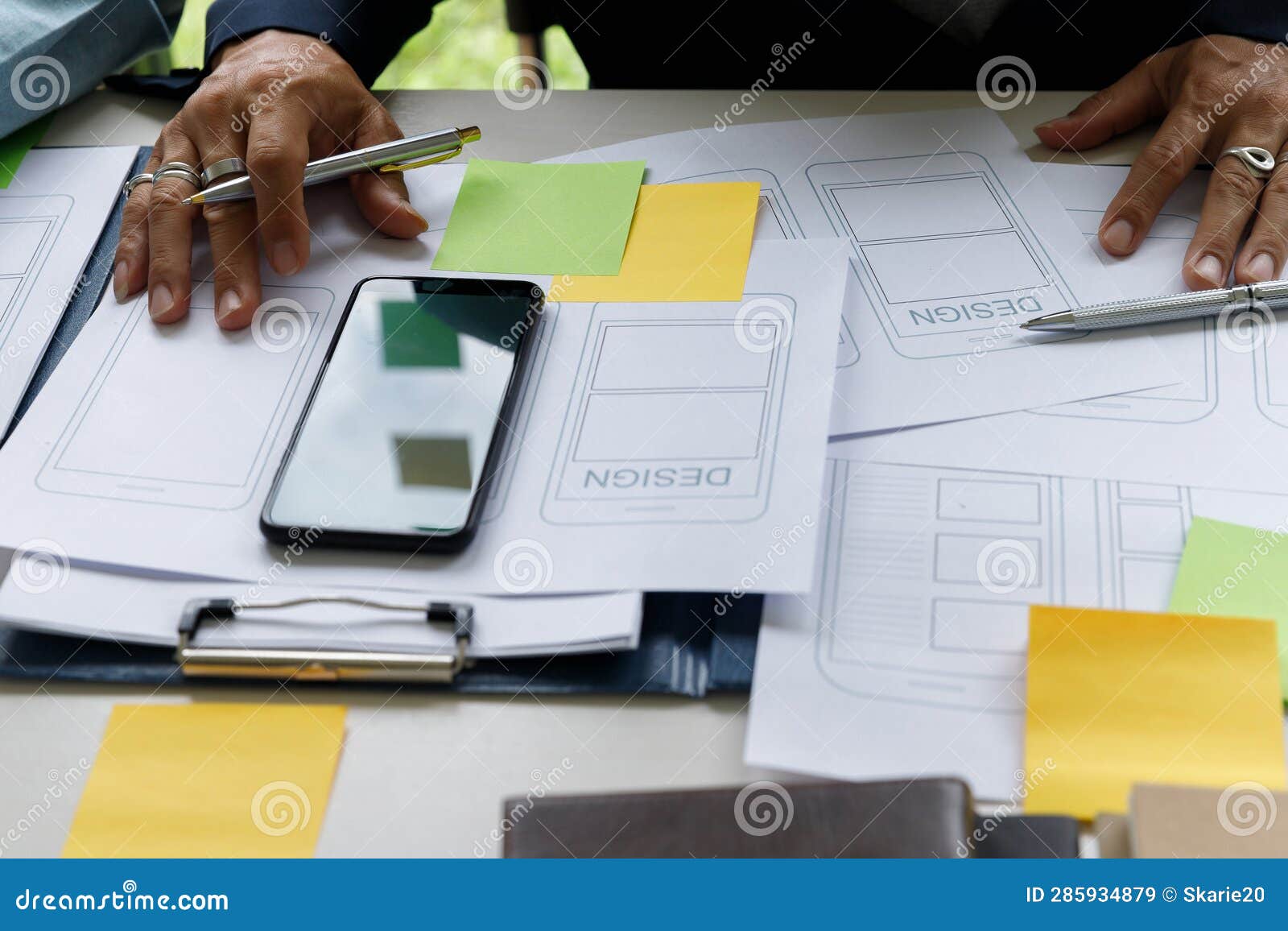 UX or UI Designers Designing on Their Smartphone Application Layout ...