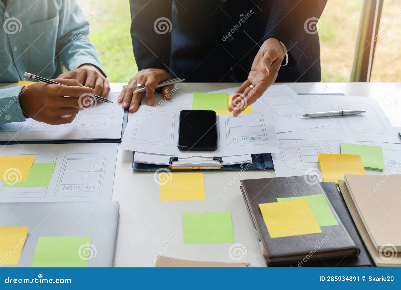 UX or UI Designers Designing on Their Smartphone Application Layout ...