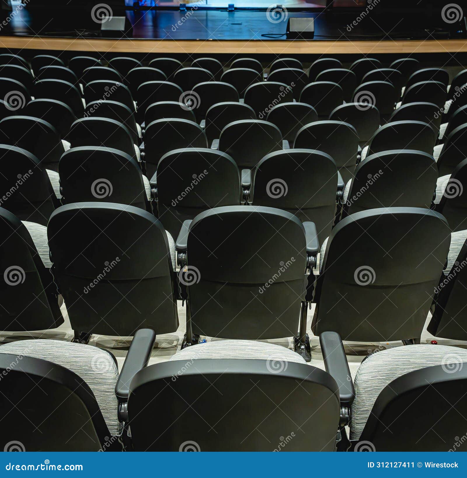 Empty Seats Sit in an Auditorium Under a Spotlight from the Stage Stock ...