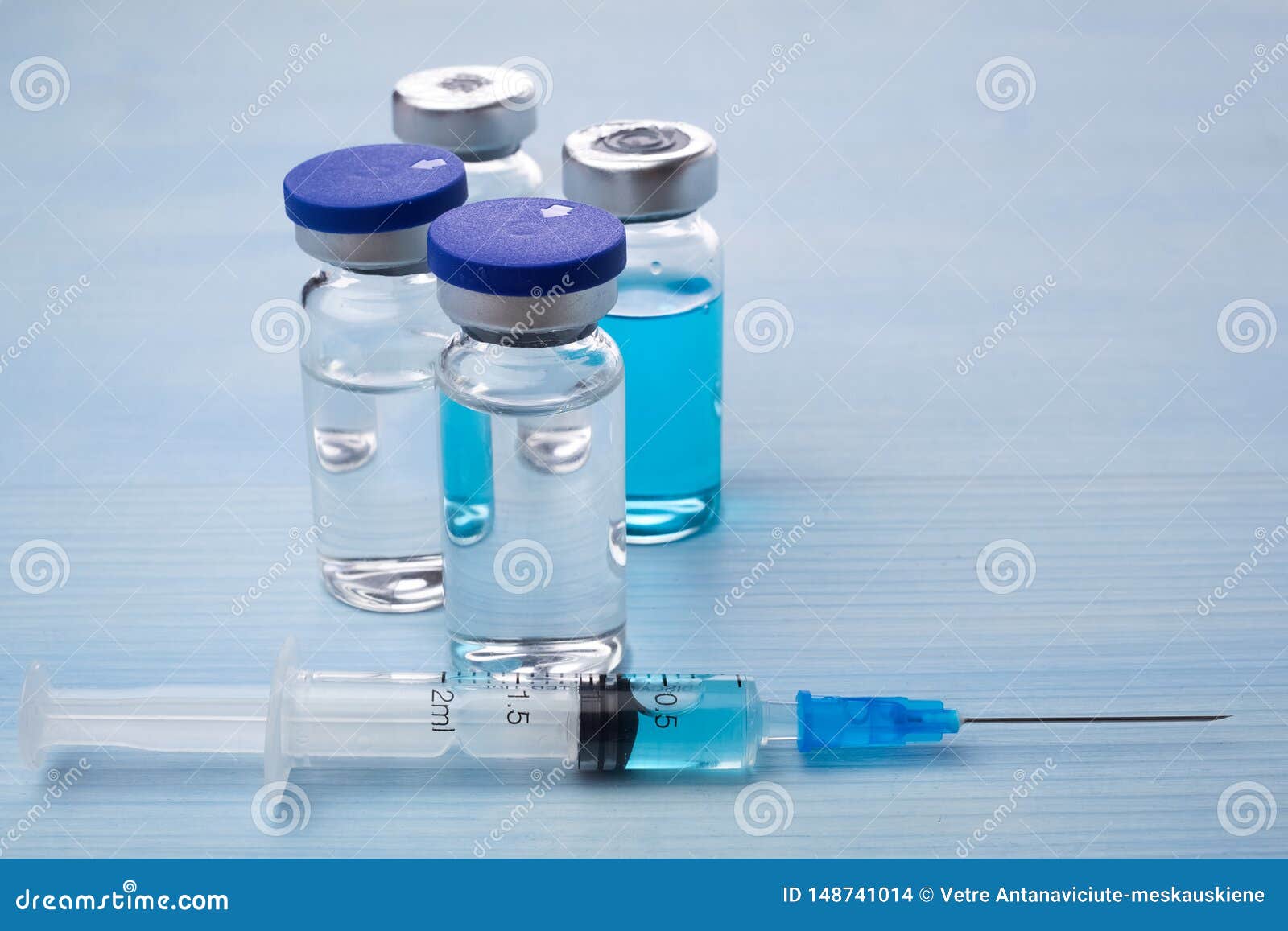 Vaccines and Syringes on Blue Wooden Table Stock Photo - Image of care ...