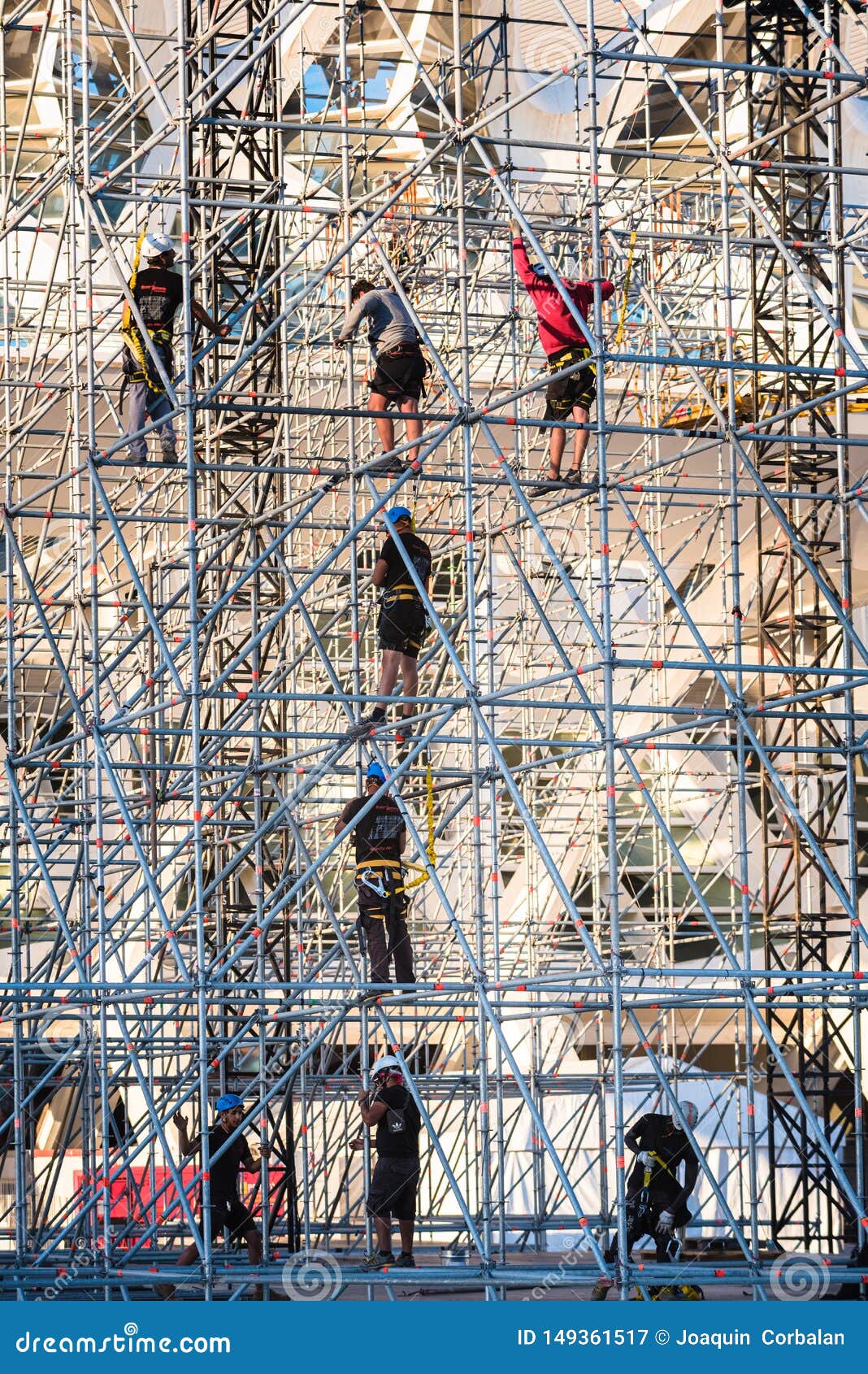 Workers Assembling a Stage for a Concert, Hanging from the Metal Bars ...