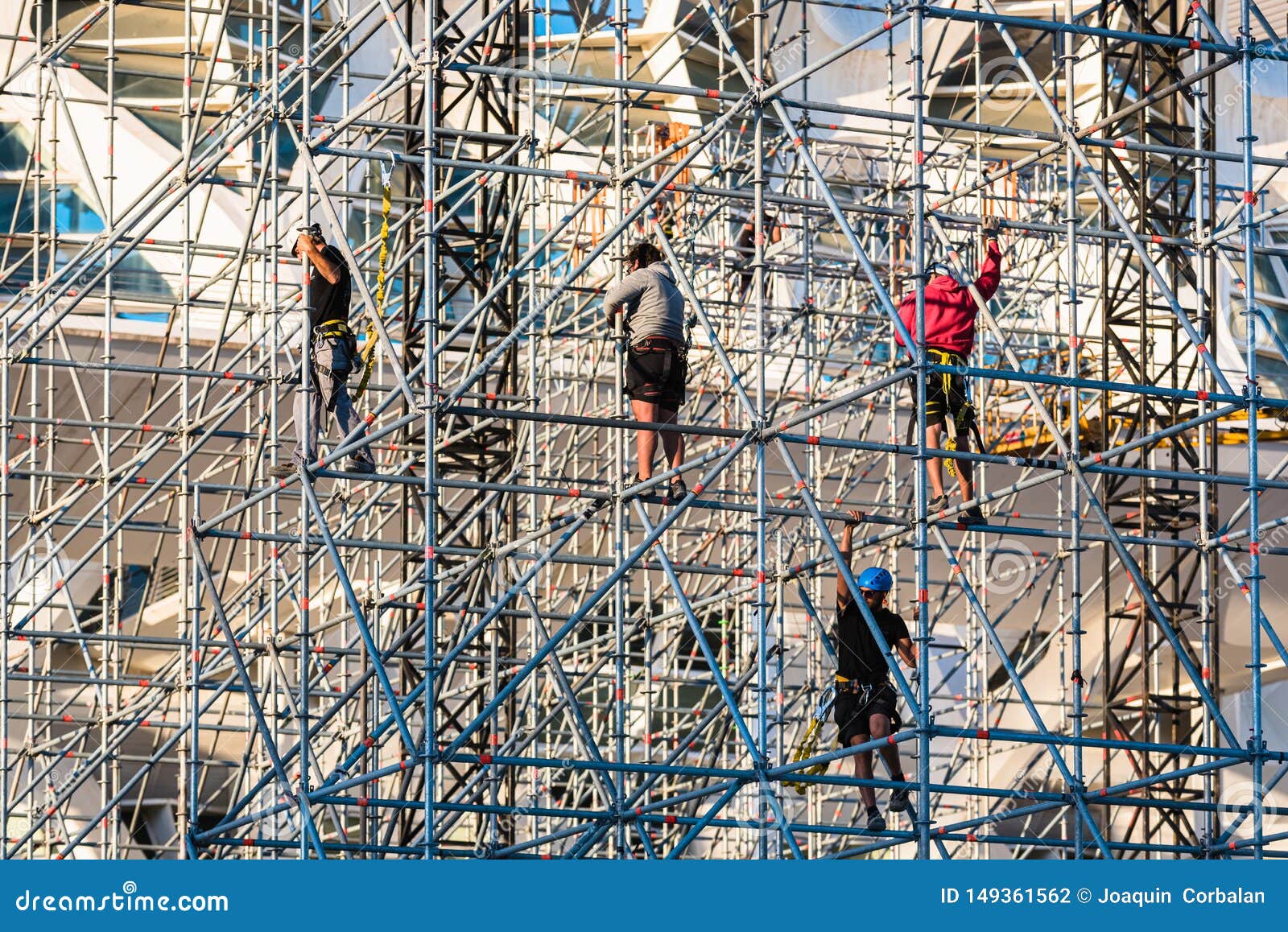 Workers Assembling a Stage for a Concert, Hanging from the Metal Bars ...