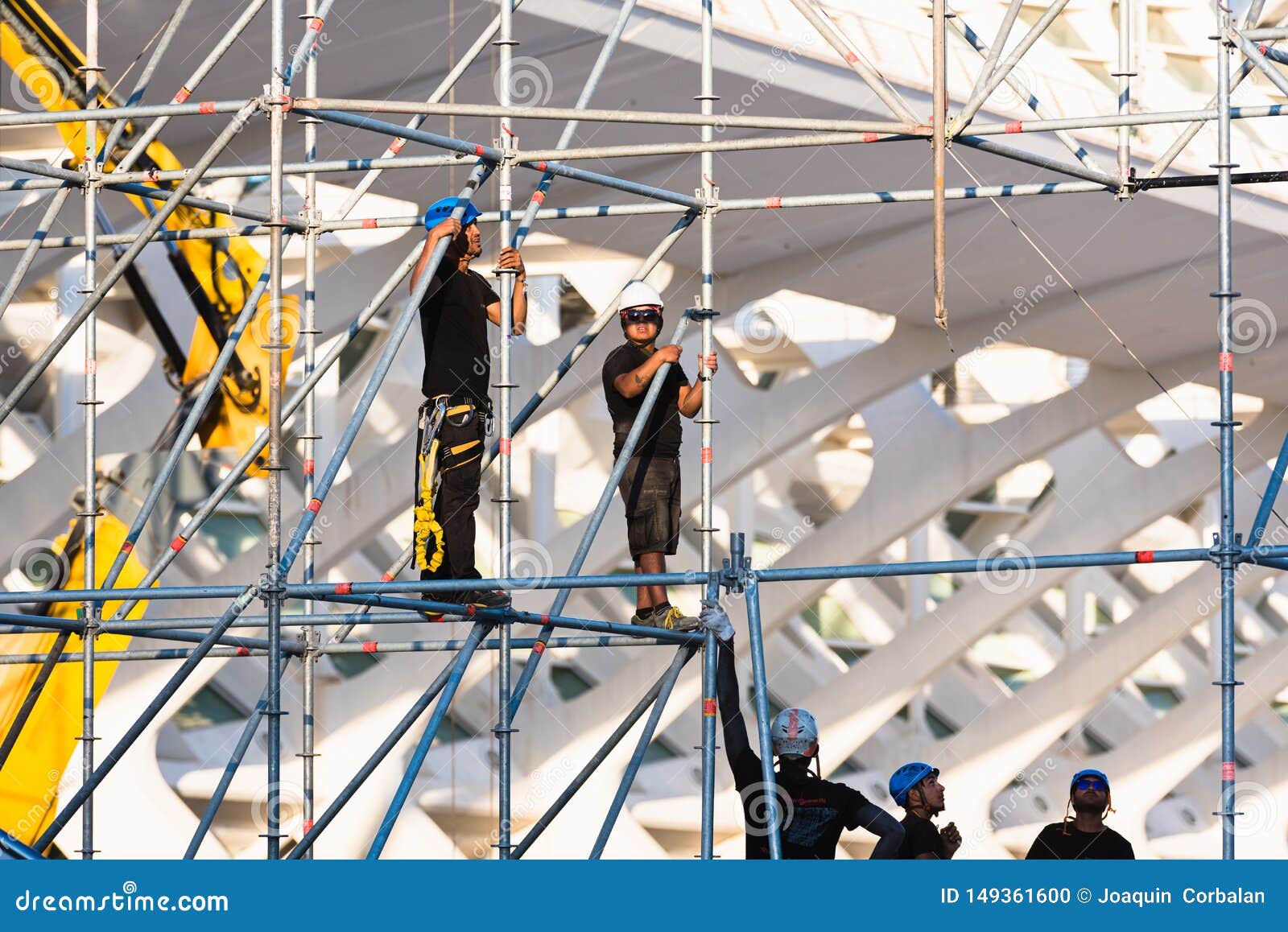 Workers Assembling a Stage for a Concert, Hanging from the Metal Bars ...