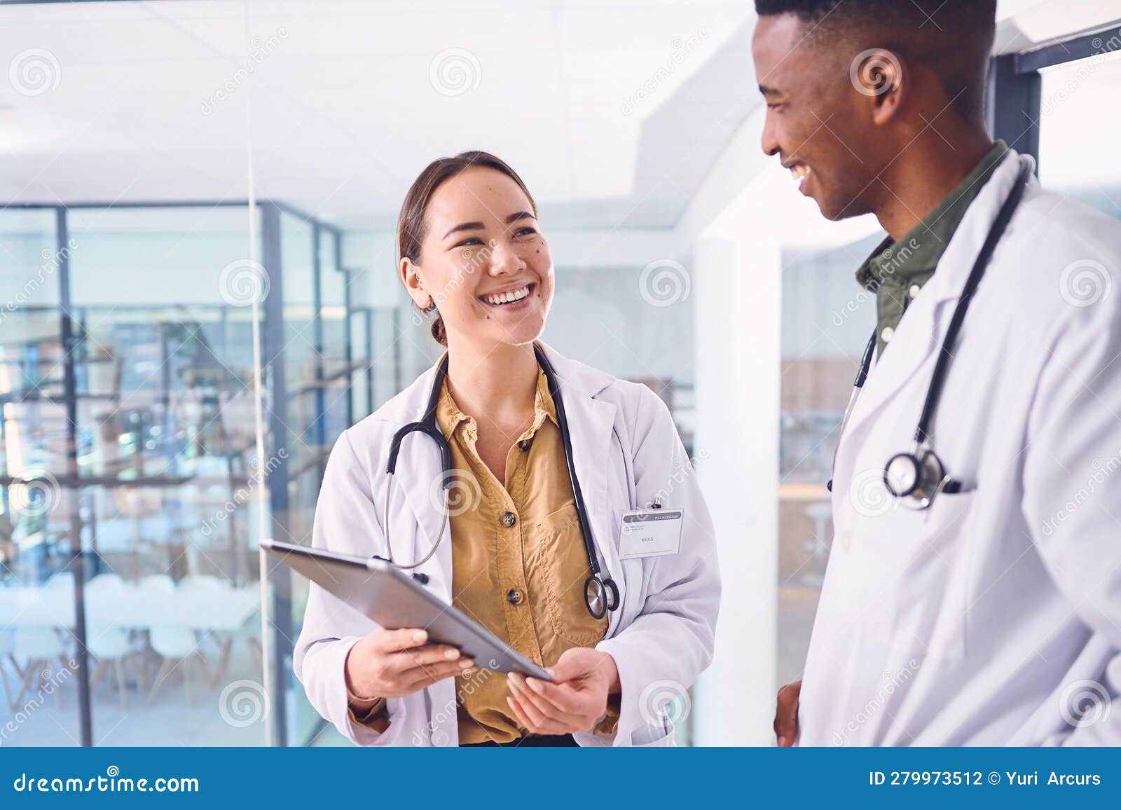 She Values His Input. Two Young Doctors Working on a Digital Tablet ...
