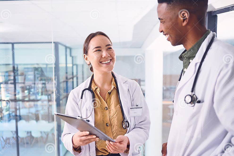 She Values His Input. Two Young Doctors Working on a Digital Tablet ...