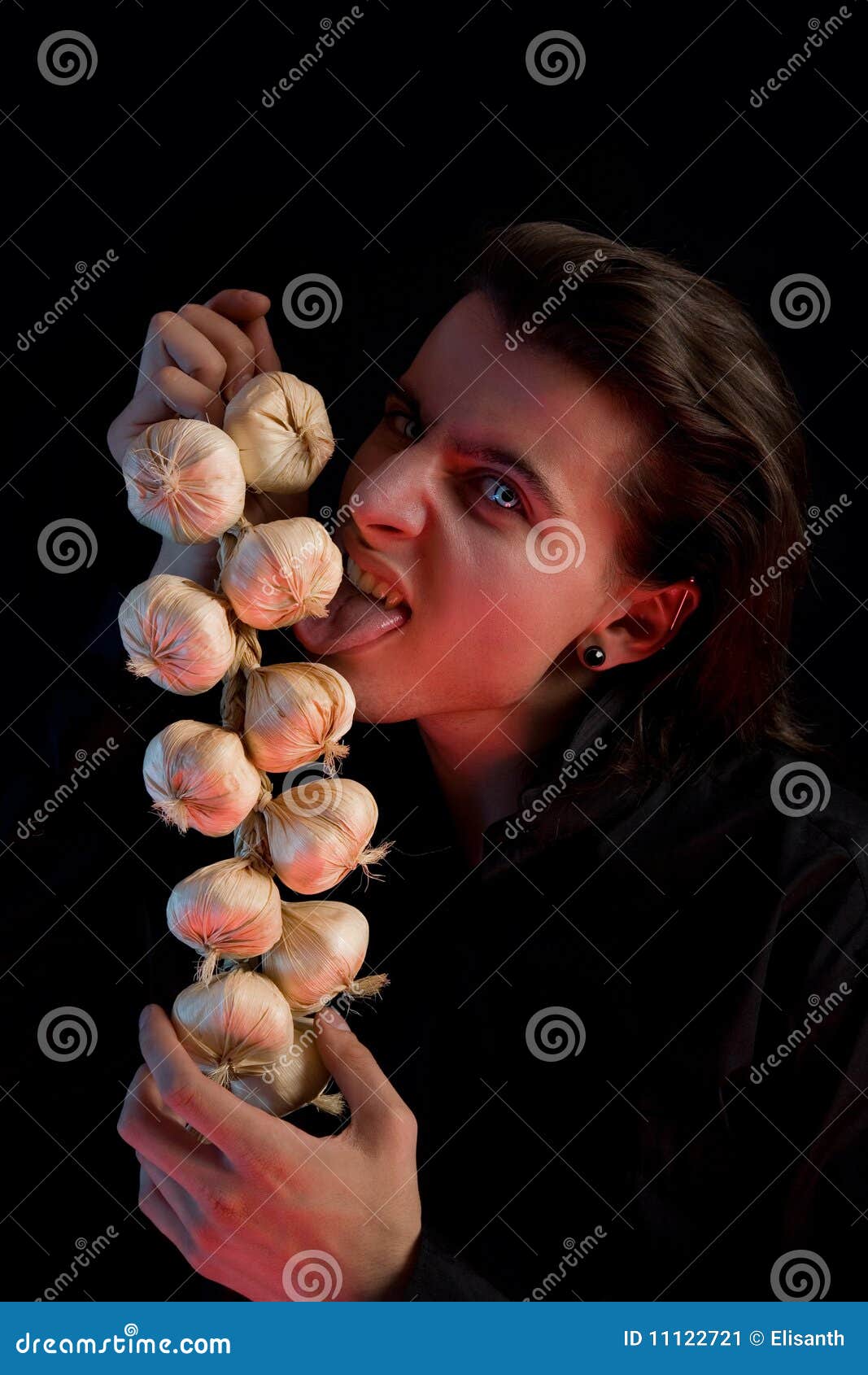 Vampire with Scary Eyes is Licking Garlic Stock Image - Image of evil ...