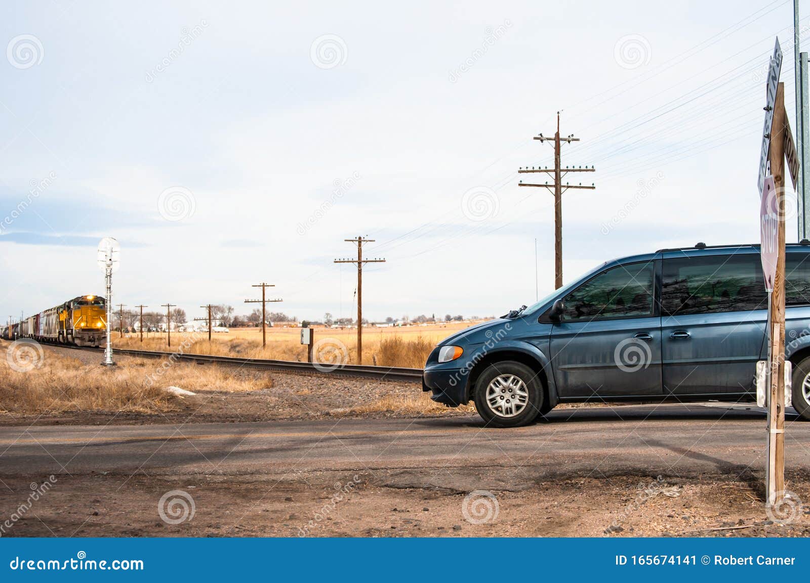 A Van Crossing the Tracks in Front of a Train Stock Image - Image of ...
