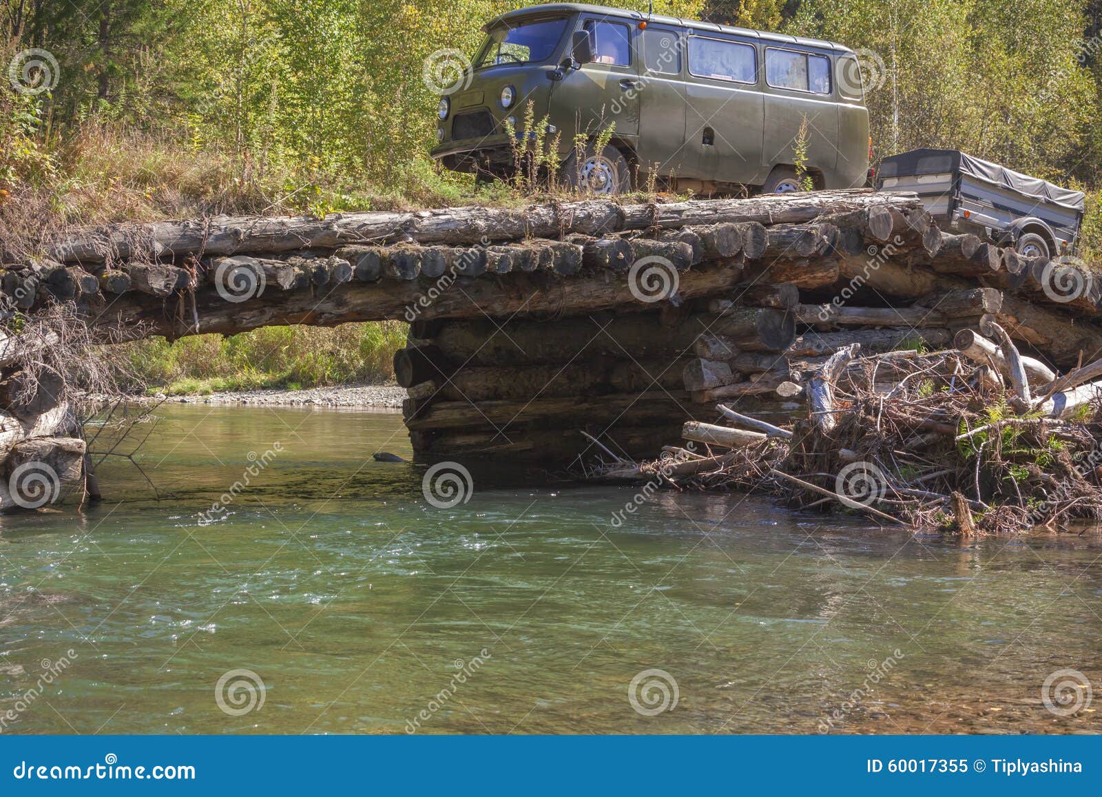 Van SUV with a Trailer on a Log Bridge through the Forest River Stock ...
