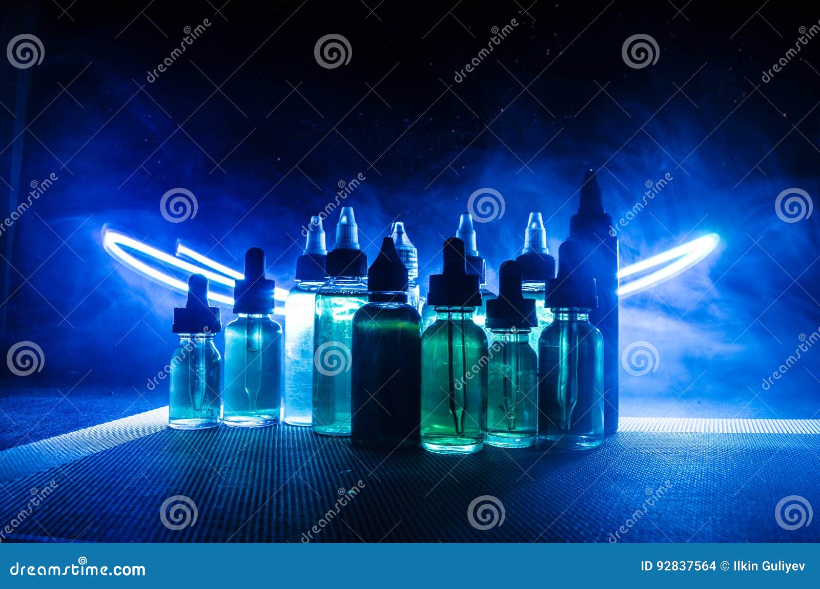 Vape Concept. Smoke Clouds And Vape Liquid Bottles On Dark Background ...