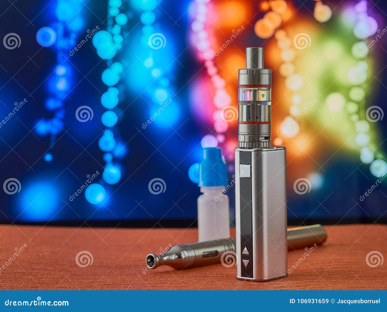 Vaping Mod E-cig with Tank Atomizer and Bottle Over Colorful Background ...