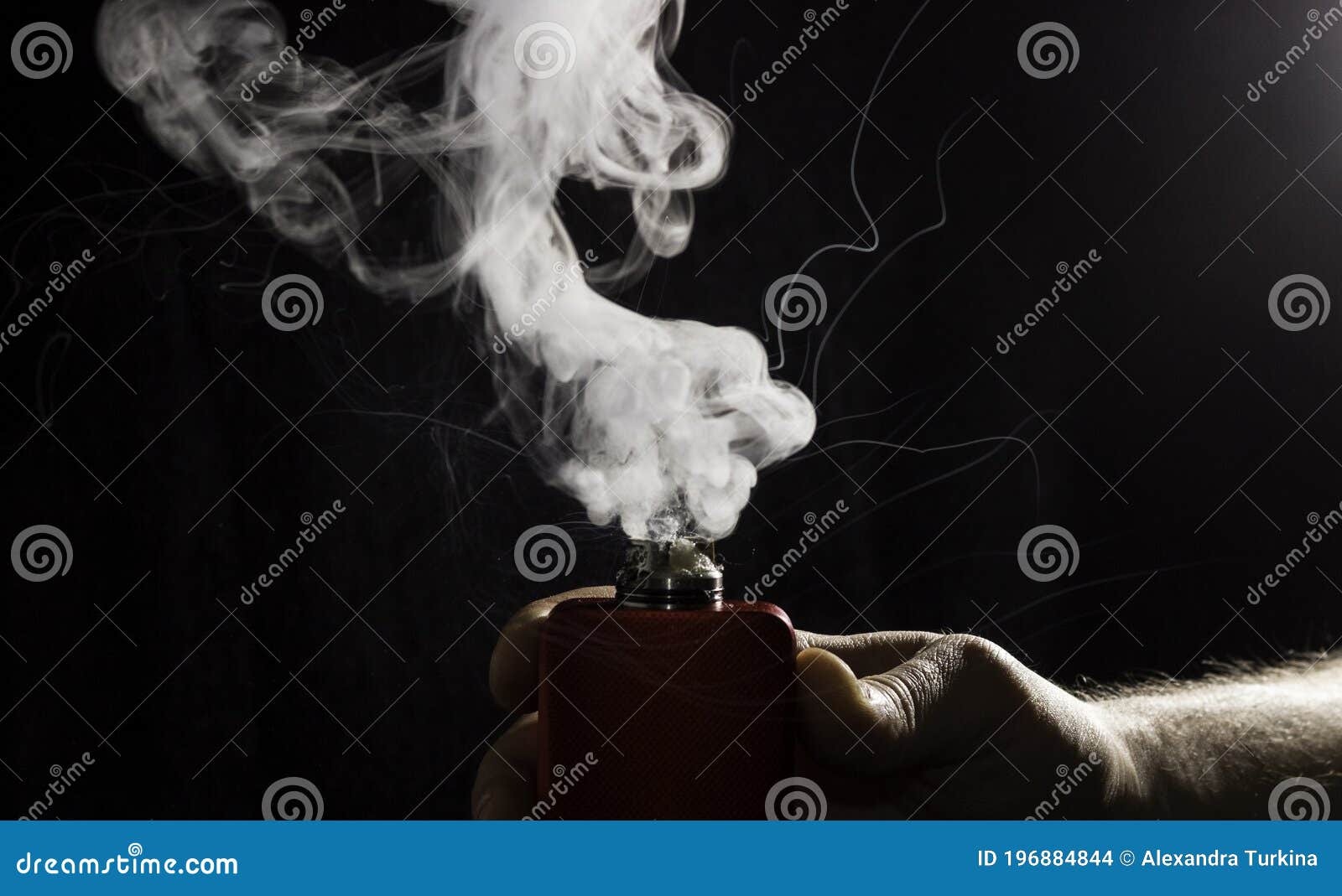 VAPE in a Man`s Hand with a Cloud of Thick Steam on a Black Background ...