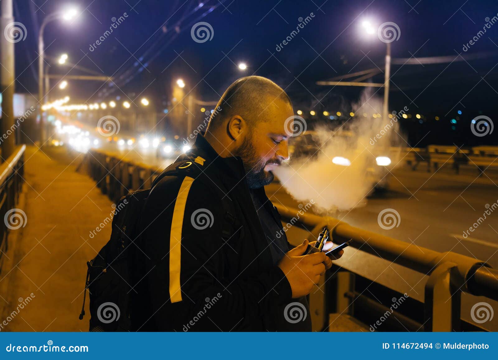 Vaping by Electronic Cigarette Fat Man Using Smart-phone on the Bridge ...