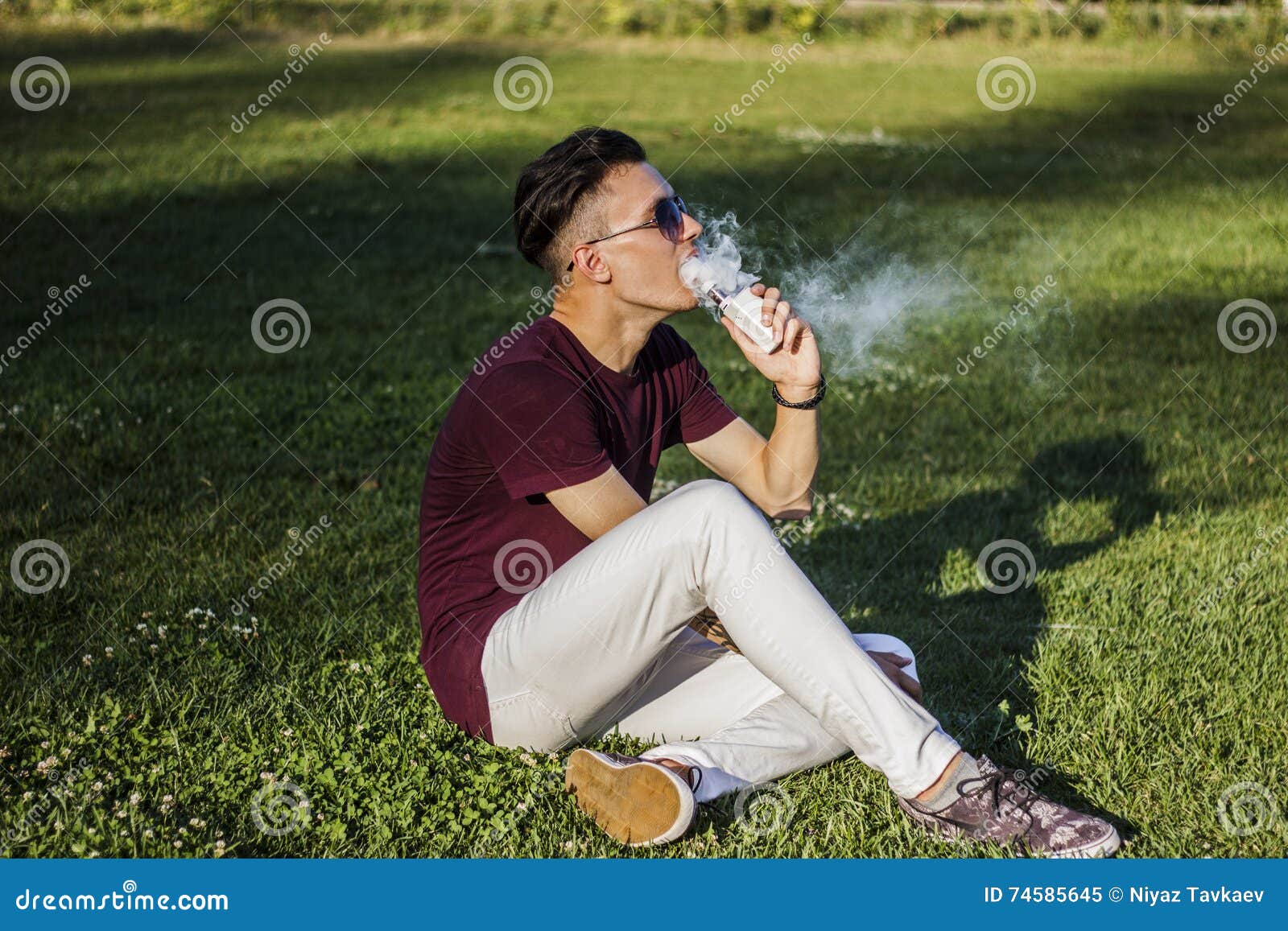 Vaping man in the park stock image. Image of closeup - 74585645