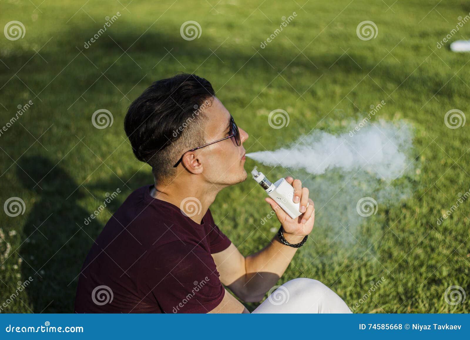 Vaping man in the park stock photo. Image of businessman - 74585668