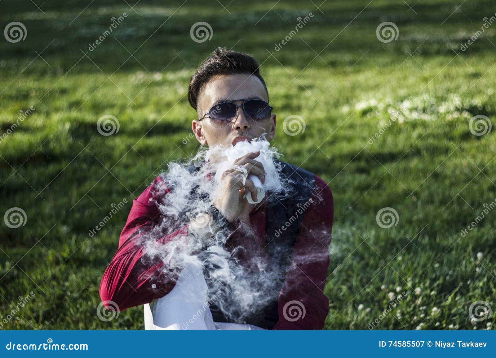 Vaping man in the park stock image. Image of inside, male - 74585507
