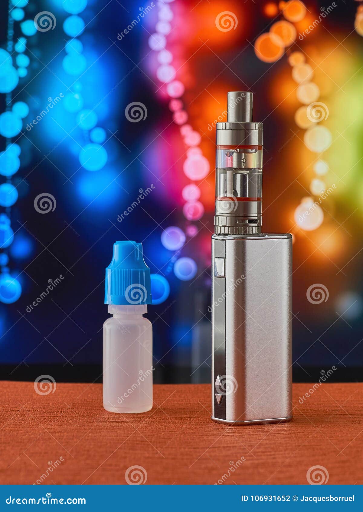 Vaping Mod E-cig with Tank Atomizer and Bottle Over Colorful Background ...
