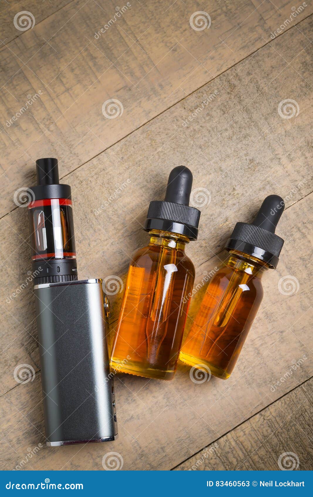 Vaping Mod E-cig with Tank Atomizer and Juice Bottles Over Wood Stock ...