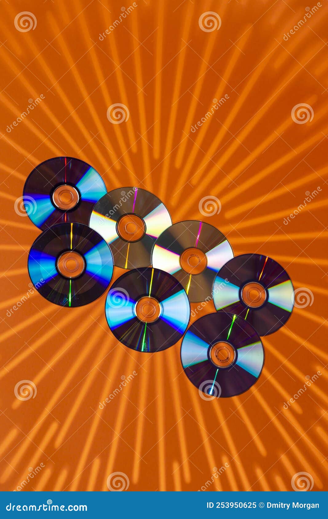 Variety of Arranged CD Disks or DVD Disks on Orange Background with ...