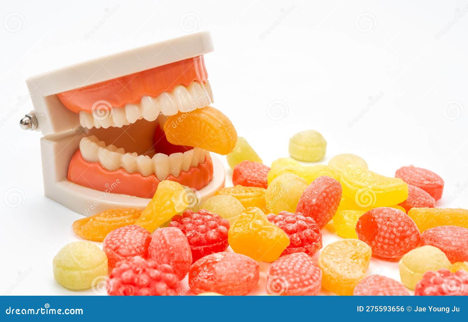 A Variety Of Colored Candies On A White Background, With A Tooth Model ...