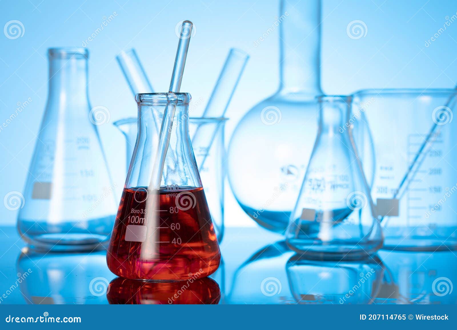 Variety of Glass Flasks and Lab Equipment with Red Liquid on a Table ...