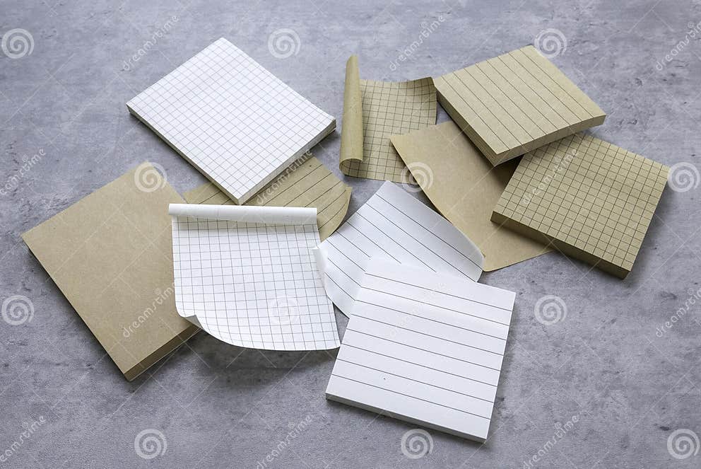 Variety of Paper Types: Lined, Grid, and Plain Sheets on a Gray Surface ...