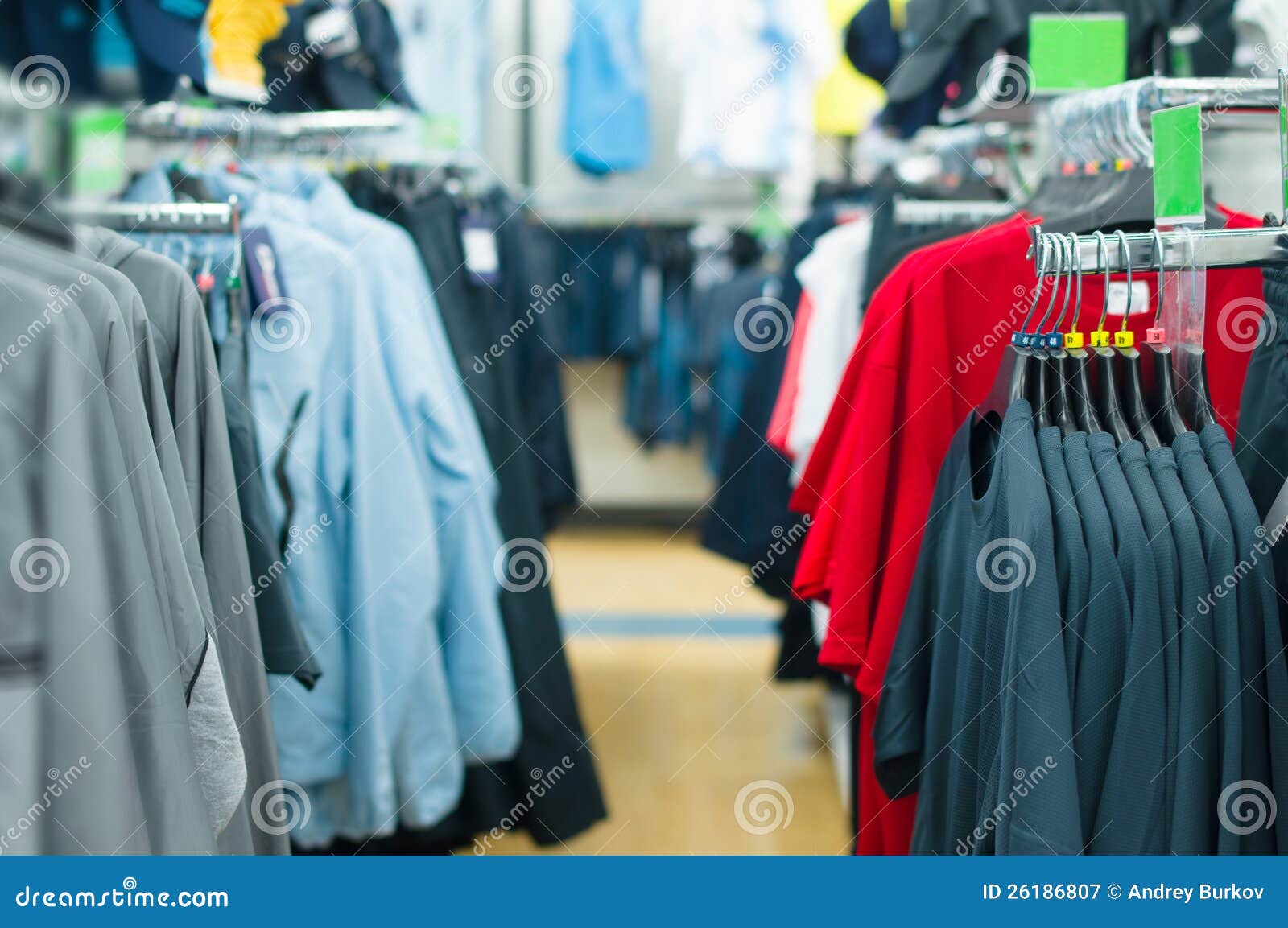 Variety of Shirts, T-shirts and Jackets on Stands Stock Image - Image ...