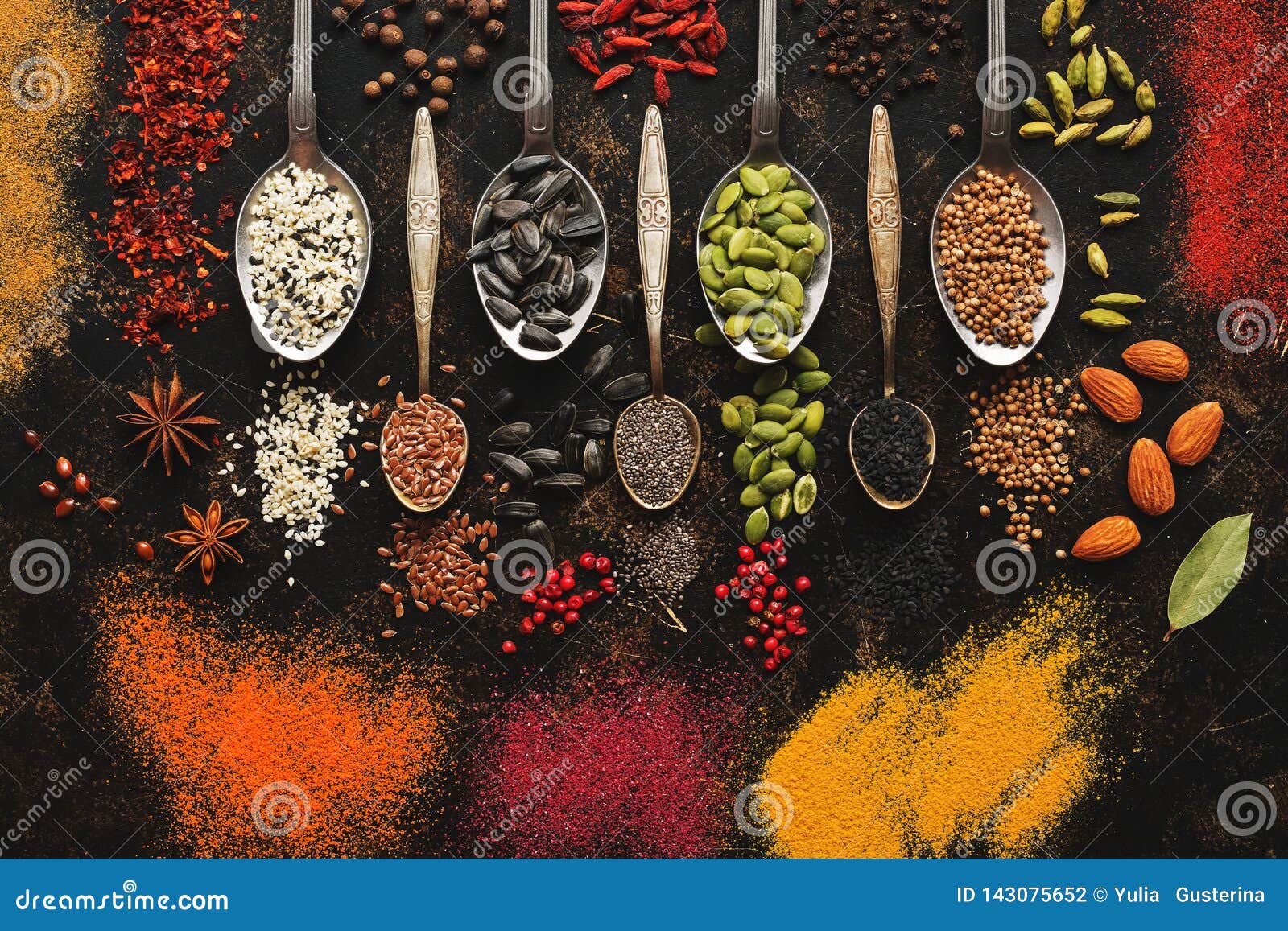 A Variety of Spices, Seeds, Nuts in Spoons on a Dark Rustic Background ...