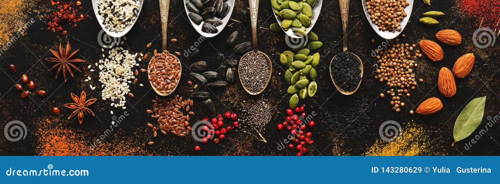 A Variety of Spices, Seeds, Nuts in Spoons on a Dark Rustic Background ...