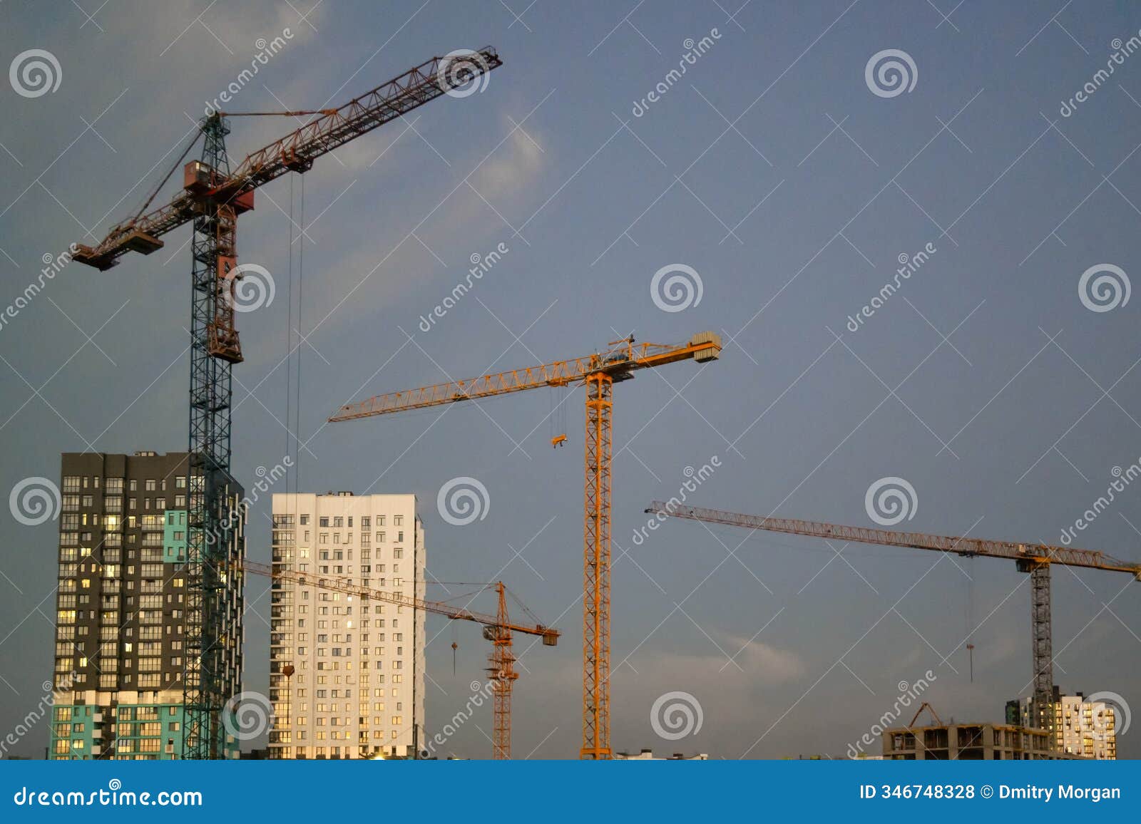 A Tower Construction Crane On The Background Of A Blue Sky With Clouds ...