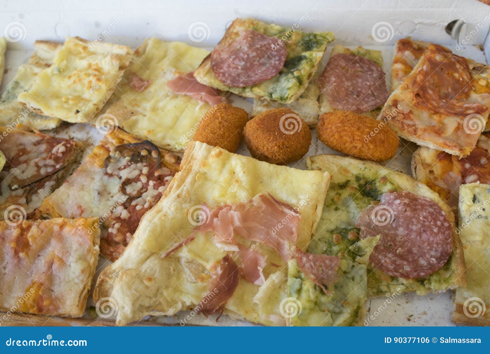 Variety of Types of Pizza Cut in Pieces and Arancine Stock Photo ...