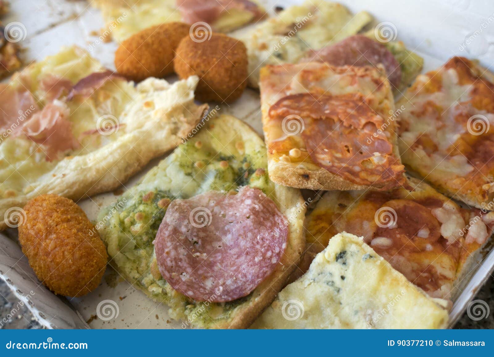 Variety of Types of Pizza Cut in Pieces and Arancine Stock Photo ...