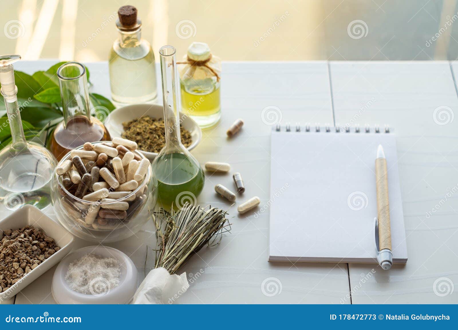 Various Capsules with Dietary Supplements, Ingredients and a Notebook ...