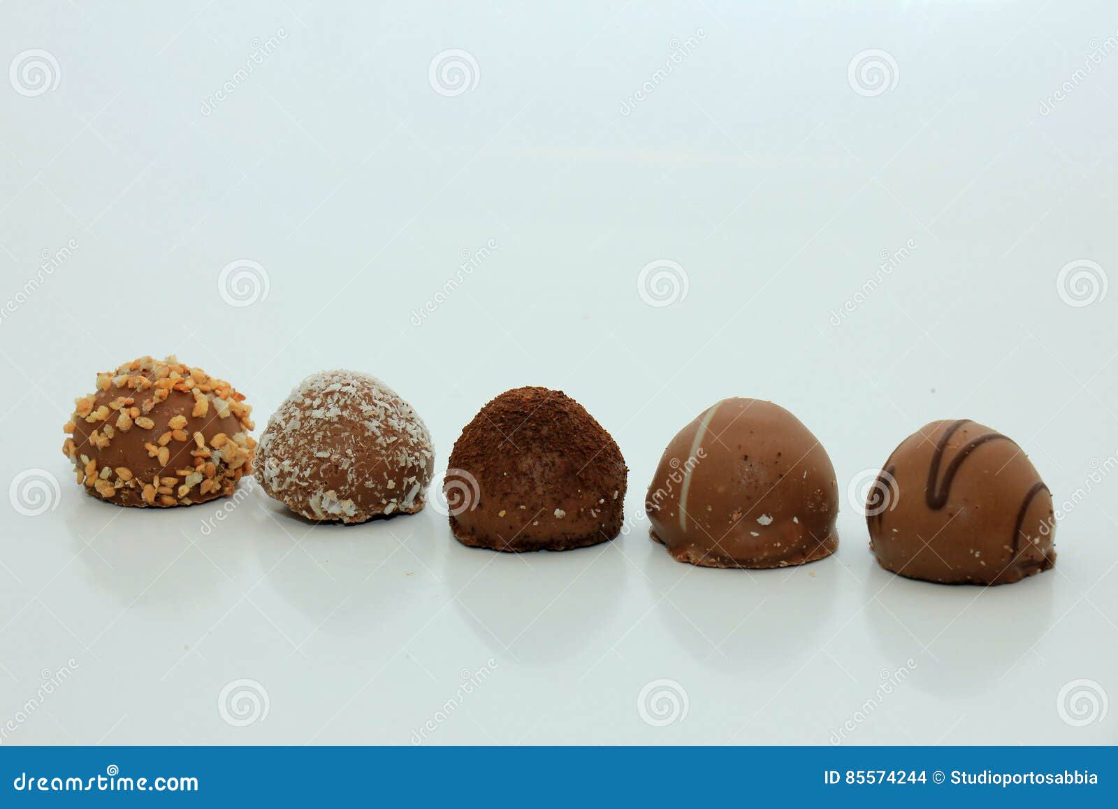 Various Chocolates in a Row Stock Photo - Image of truffle, chocolate ...