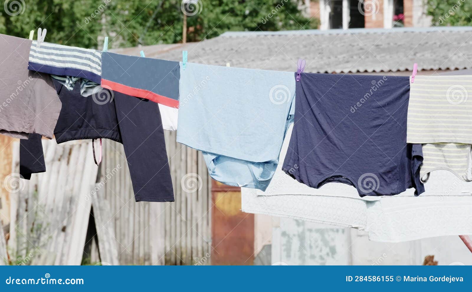 Various Clothes are Drying on the Laundry Line Against the Backdrop of ...