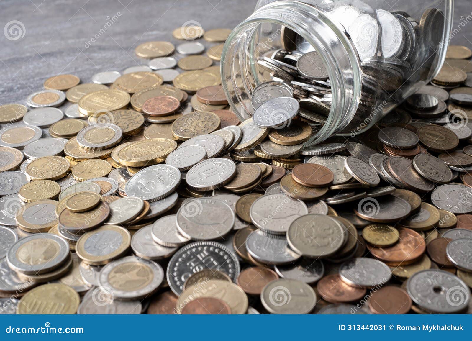 Various Coins are Falling Out of a Glass Jar, Concept of Saving Money ...