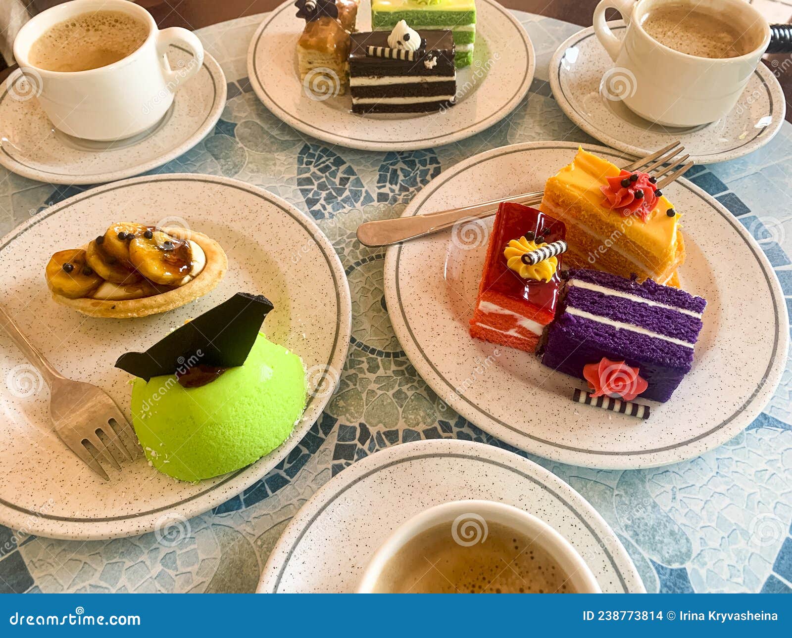 Various Colored Cakes on Plates. Sweet Desserts. Studio Photo Stock ...