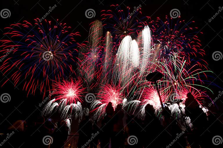 Various Colored Fireworks with Silhouette of People. Stock Photo ...