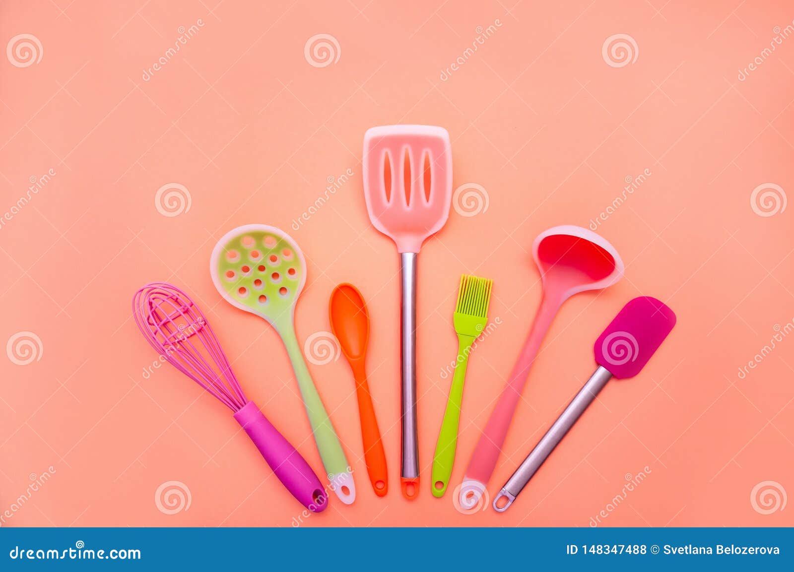 Various Colored Silicone Kitchen Utensils on Coral Background. Copy ...