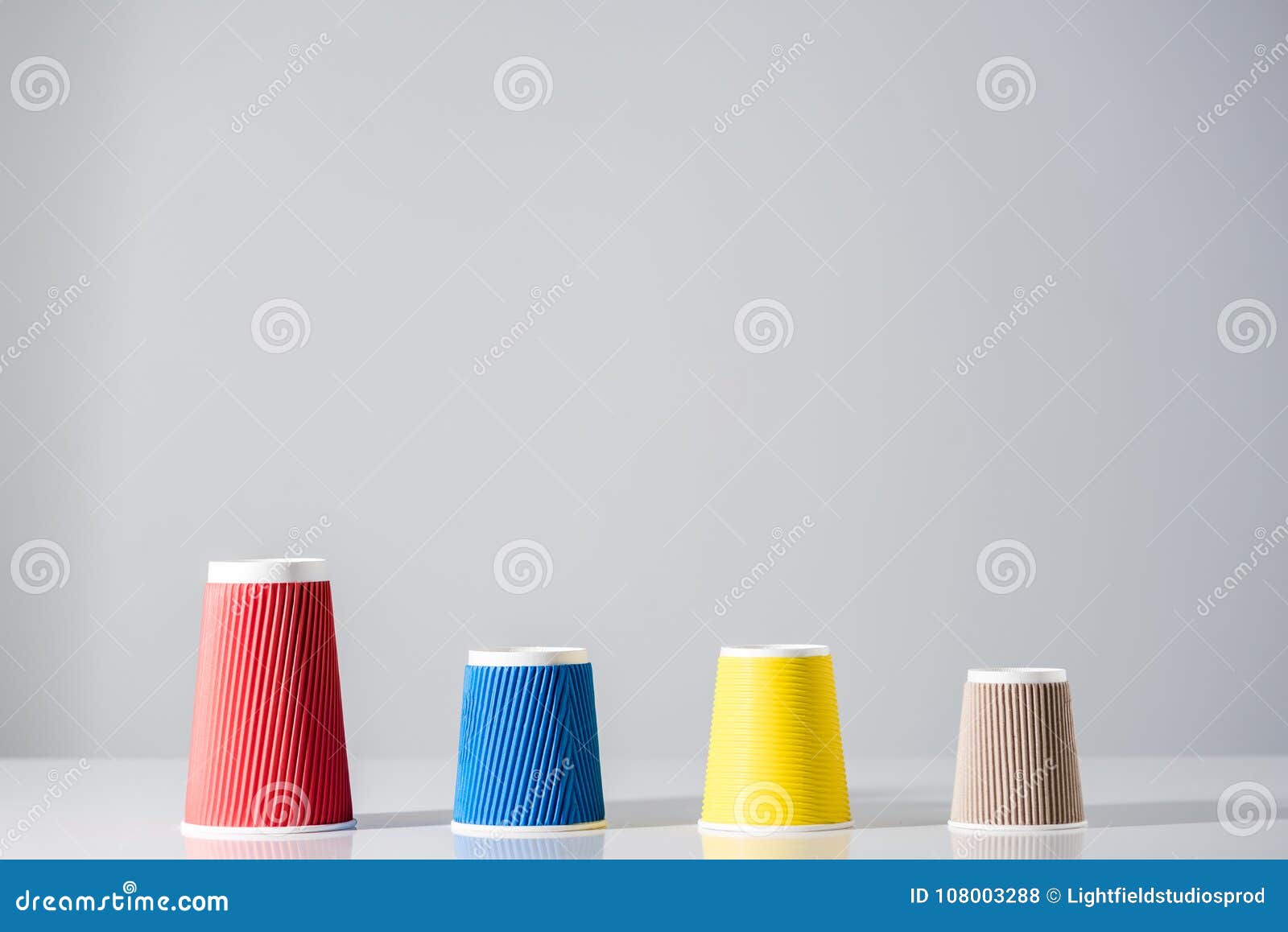 Colorful Paper Cups in a Row on Grey Stock Photo - Image of disposable ...
