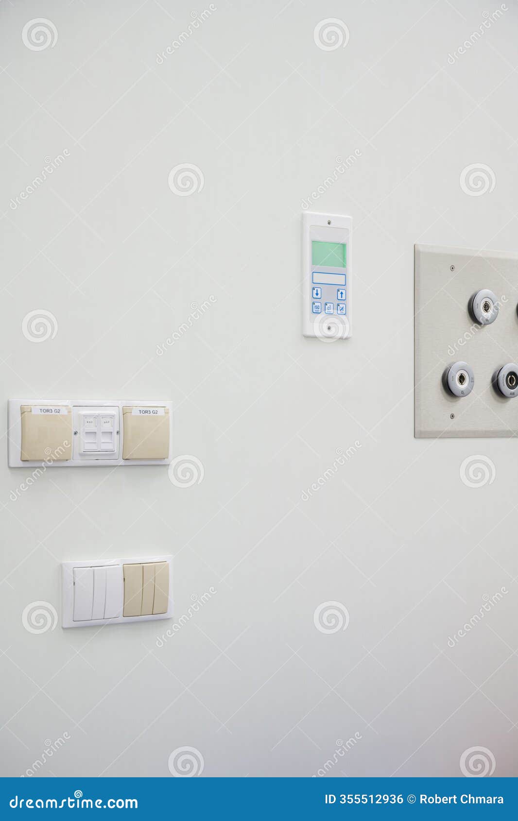 Various Control Panels and Electrical Switches on a White Wall in ...