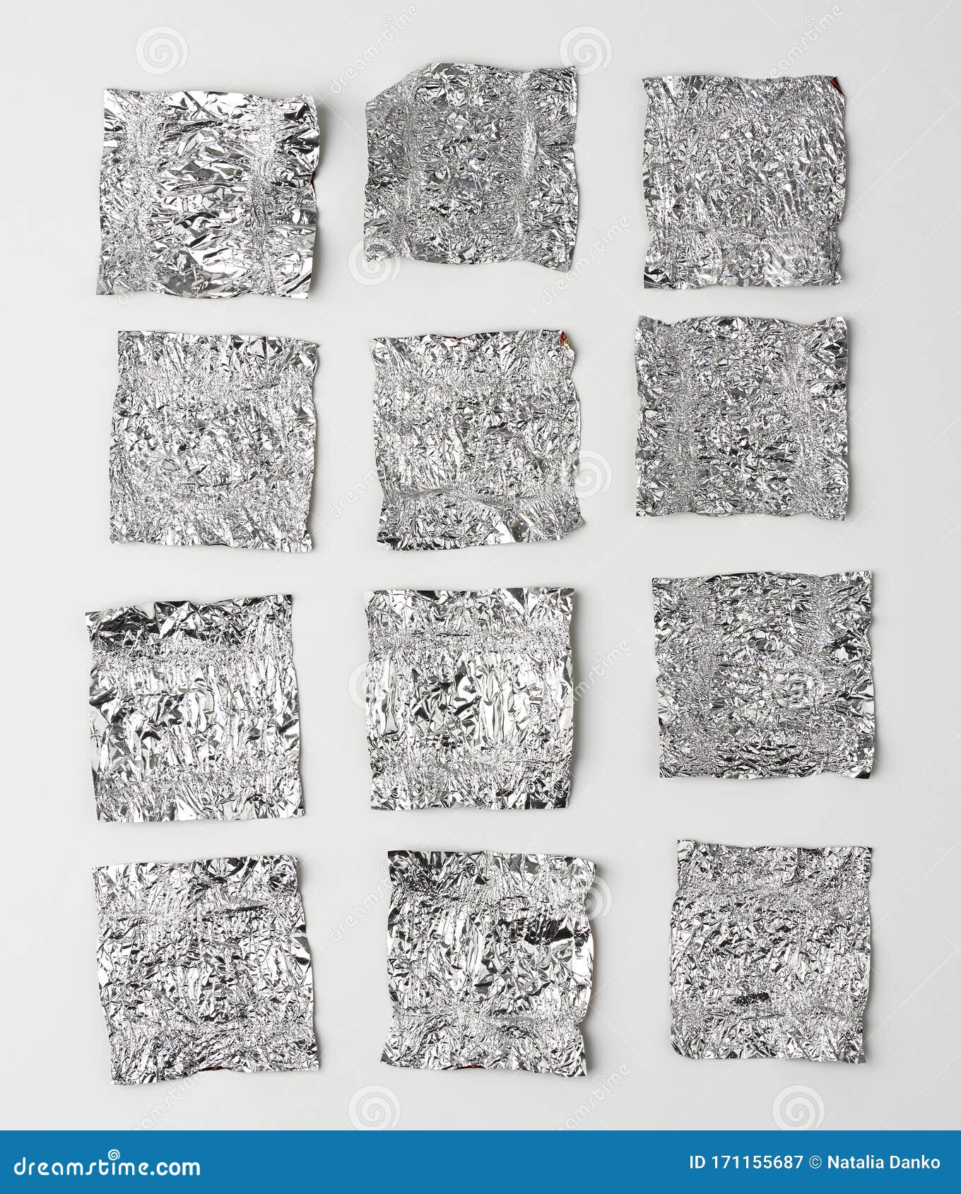 Various Crumpled Foil Used Candy Wrappers on a White Background Stock ...