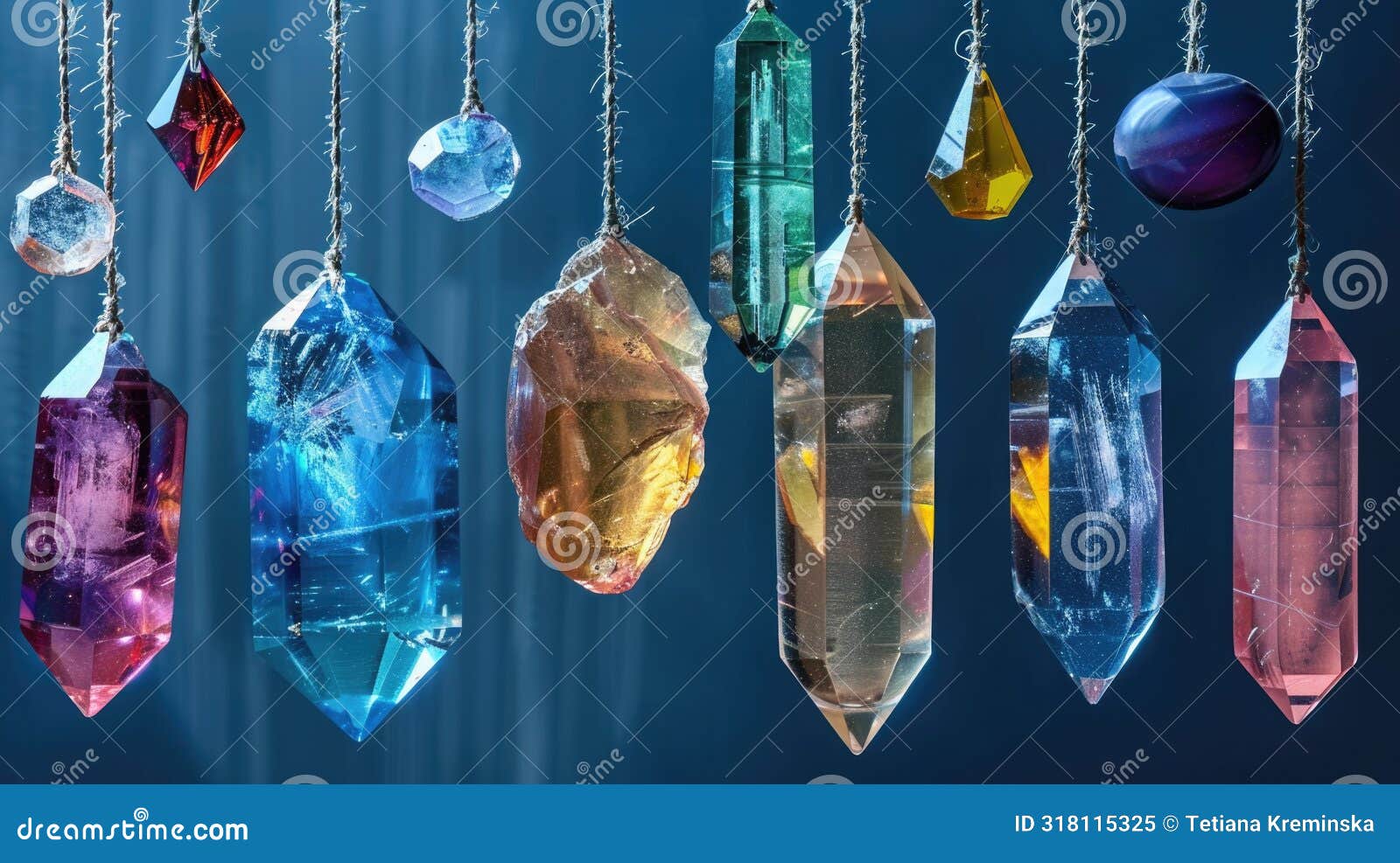 Various Crystals Hanging on Delicate Strings Against a Deep Blue ...